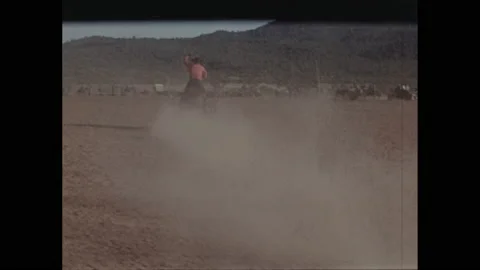 1970s: Cow is chased by man on horse in ... | Stock Video | Pond5