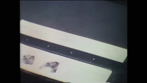 1970s: FBI agent looks at sheets of fing... | Stock Video | Pond5