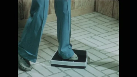 1970s: Feet on scale, step off. Close up... | Stock Video | Pond5