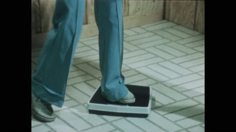 1970s: Feet on scale, step off. Close up... | Stock Video | Pond5