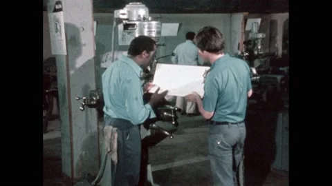 1970s: Machine shop, men stand by drill ... | Stock Video | Pond5