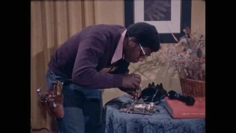 1970s: Man stands at table in house work... | Stock Video | Pond5