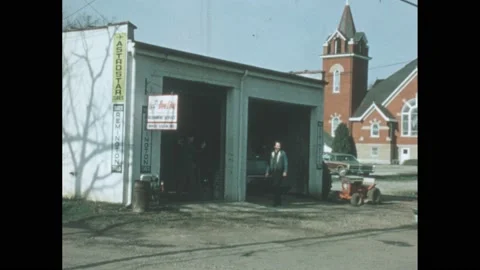 1970s: Men open doors at auto mechanic's... | Stock Video | Pond5