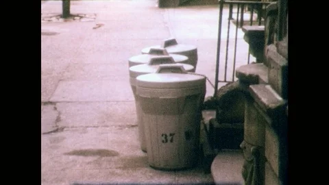 1970s: Plastic garbage bins on side of r... | Stock Video | Pond5