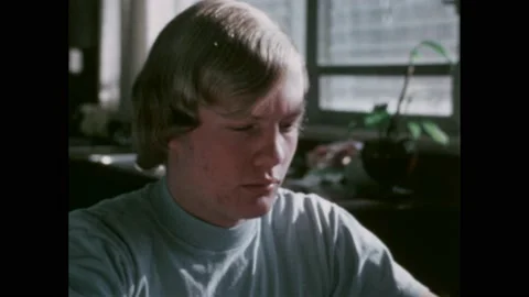 1970s: students look at paper. Boy looks... | Stock Video | Pond5
