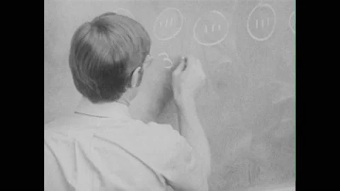 1970s: Teacher writes an equation on cha... | Stock Video | Pond5