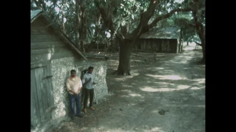 1970s: Two black men lean against small ... | Stock Video | Pond5