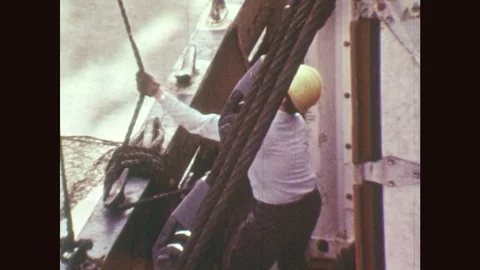1970s: Two men in helmets pull ship rope... | Stock Video | Pond5