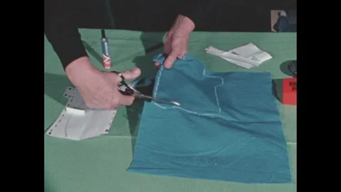 1970s: Woman cuts shape out of fabric. W... | Stock Video | Pond5