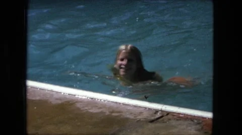 1974: cute blonde girl swimming in pool ... | Stock Video | Pond5