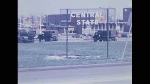 1974 - US Army trucks drive up to a buil... | Stock Video | Pond5