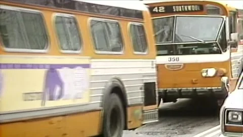1980S LINE OF CITY BUSES DRIVING IN BUSY... | Stock Video | Pond5