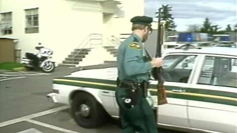 1980s Sheriff walking with shotgun to hi... | Stock Video | Pond5