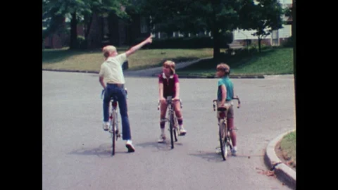 1980s: Three kids sit on bicycles on roa... | Stock Video | Pond5