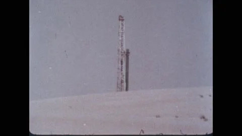 1980s: Tilt up sand dunes, zoom in on oi... | Stock Video | Pond5