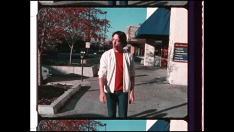 1980s: Tracking shot, man walking down s... | Stock Video | Pond5