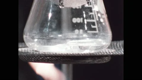 1990s: Bunsen burner heats flask, ice cu... | Stock Video | Pond5