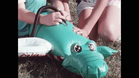 1990s: Child pushes on air pump. Alligat... | Stock Video | Pond5