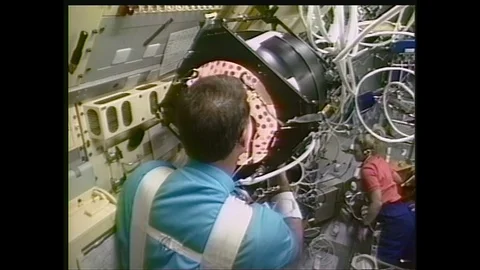 1990s: Man on space shuttle looks into s... | Stock Video | Pond5