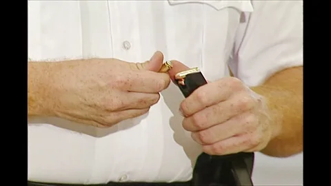 1990s: A person deftly loads bullets int... | Stock Video | Pond5