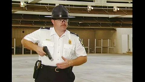 1990s: A police officer swiftly draws th... | Stock Video | Pond5