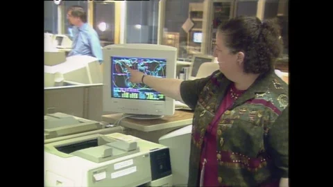 1990s: Woman points to computer. Man sp... | Stock Video | Pond5