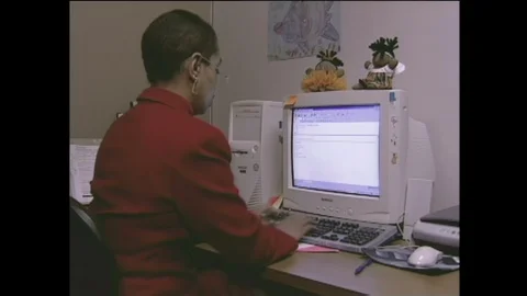 1990s: woman types at computer, man with... | Stock Video | Pond5