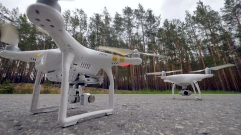 2 drones. One copter is taking off in sl... | Stock Video | Pond5