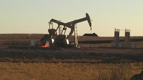 2 Pumping Units With 2 Gas Flares Wide | Stock Video | Pond5