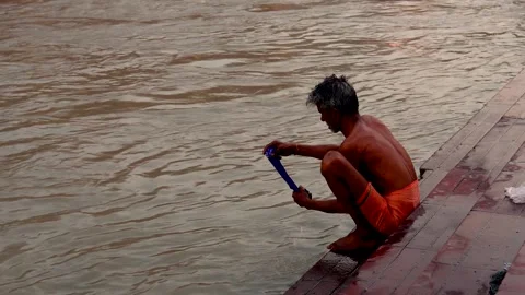 20-05-24; a Pilgrim Washing Clothes on t... | Stock Video | Pond5