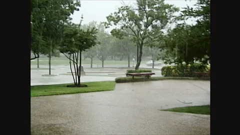 2000s: rain flooding parking lot and str... | Stock Video | Pond5
