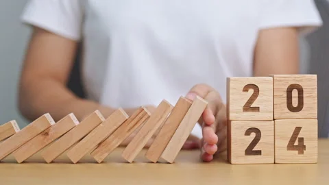 2024 year with falling blocks on table, ... | Stock Video | Pond5
