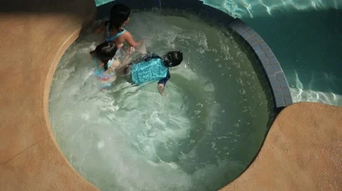 3 KIDS PLAY IN JACUZZI HIGH ANGLE IN SLO... | Stock Video | Pond5