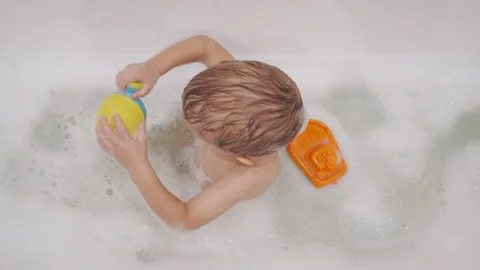 3-year-old child playing takes a bath in... | Stock Video | Pond5