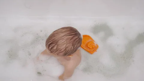 3 year old child playing takes a bath in. Stock Video Pond5