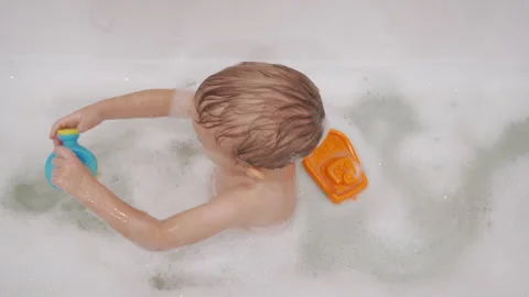 3-year-old child playing takes a bath in... | Stock Video | Pond5