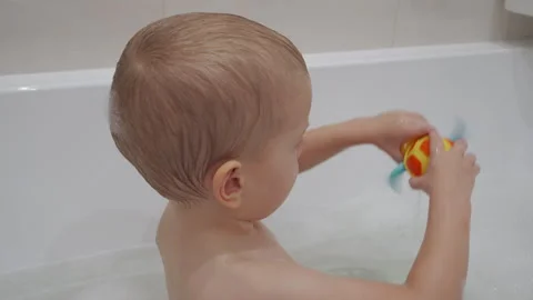 3-year-old child playing takes a bath in... | Stock Video | Pond5
