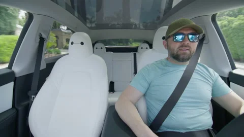 40s male driver inside Tesla Model Y car... | Stock Video | Pond5