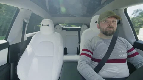 40s male driver inside Tesla Model Y car... | Stock Video | Pond5