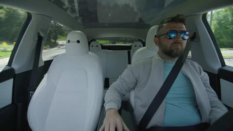 40s male driver inside Tesla Model Y car... | Stock Video | Pond5