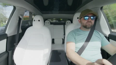 40s male driver inside Tesla Model Y car... | Stock Video | Pond5