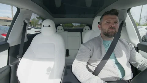 40s male driver inside Tesla Model Y car... | Stock Video | Pond5