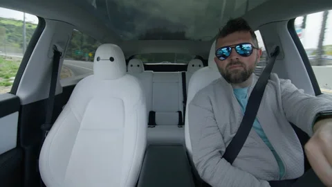 40s male driver inside Tesla Model Y car... | Stock Video | Pond5