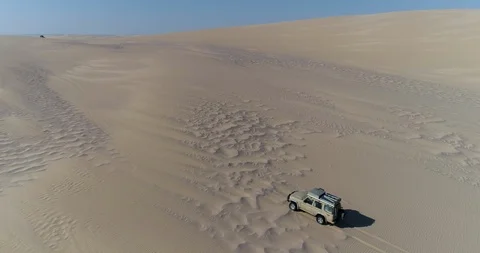 4K aerial side view of a 4x4 vehicle dri... | Stock Video | Pond5