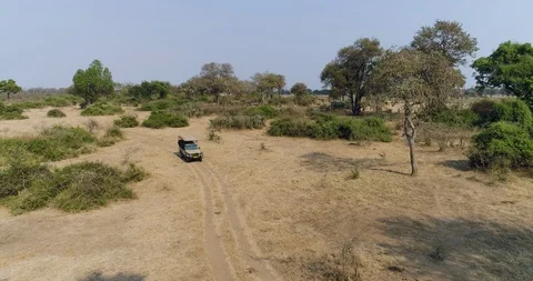 4K aerial zoom out view of a 4x4 safari ... | Stock Video | Pond5