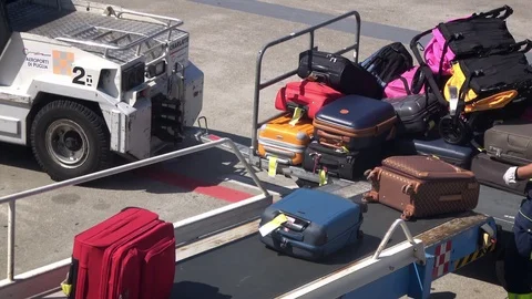 4K. Airport staff loading baggage on con... | Stock Video | Pond5
