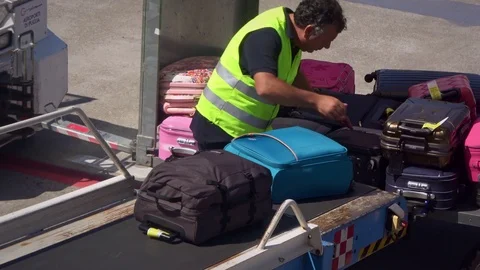 4K. Airport staff loading baggage on con... | Stock Video | Pond5