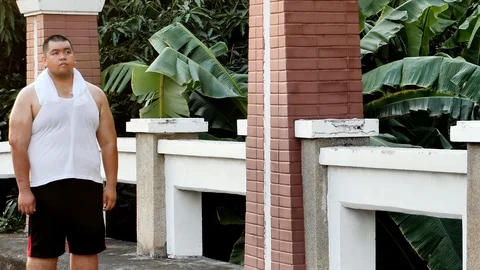 4K Asian fat man running on the bridge i... | Stock Video | Pond5