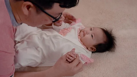 4K, Asian single dad is caring for his 3... | Stock Video | Pond5