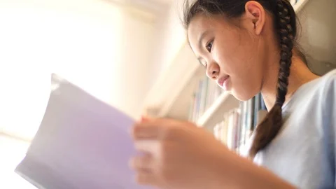 4K Asian teenager student reading a book... | Stock Video | Pond5